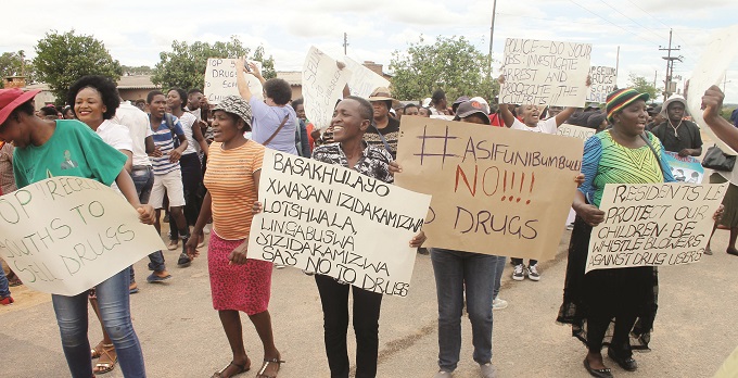Anti-drugs protest. . .Placard-waving residents besiege police station ...
